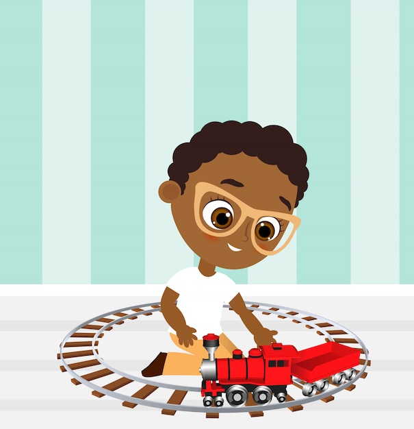 Delightful Young Boy Playing with Toy Train on Tracks | Jiffy Designs